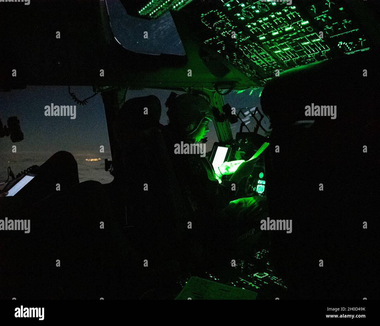 Capt. Sarah Aravich, 3rd Airlift Squadron pilot, views a map during a ...