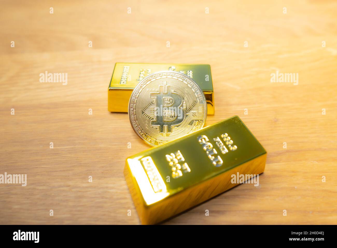 Bitcoin laying on stacked gold bars (gold ingots) rendered with shallow ...