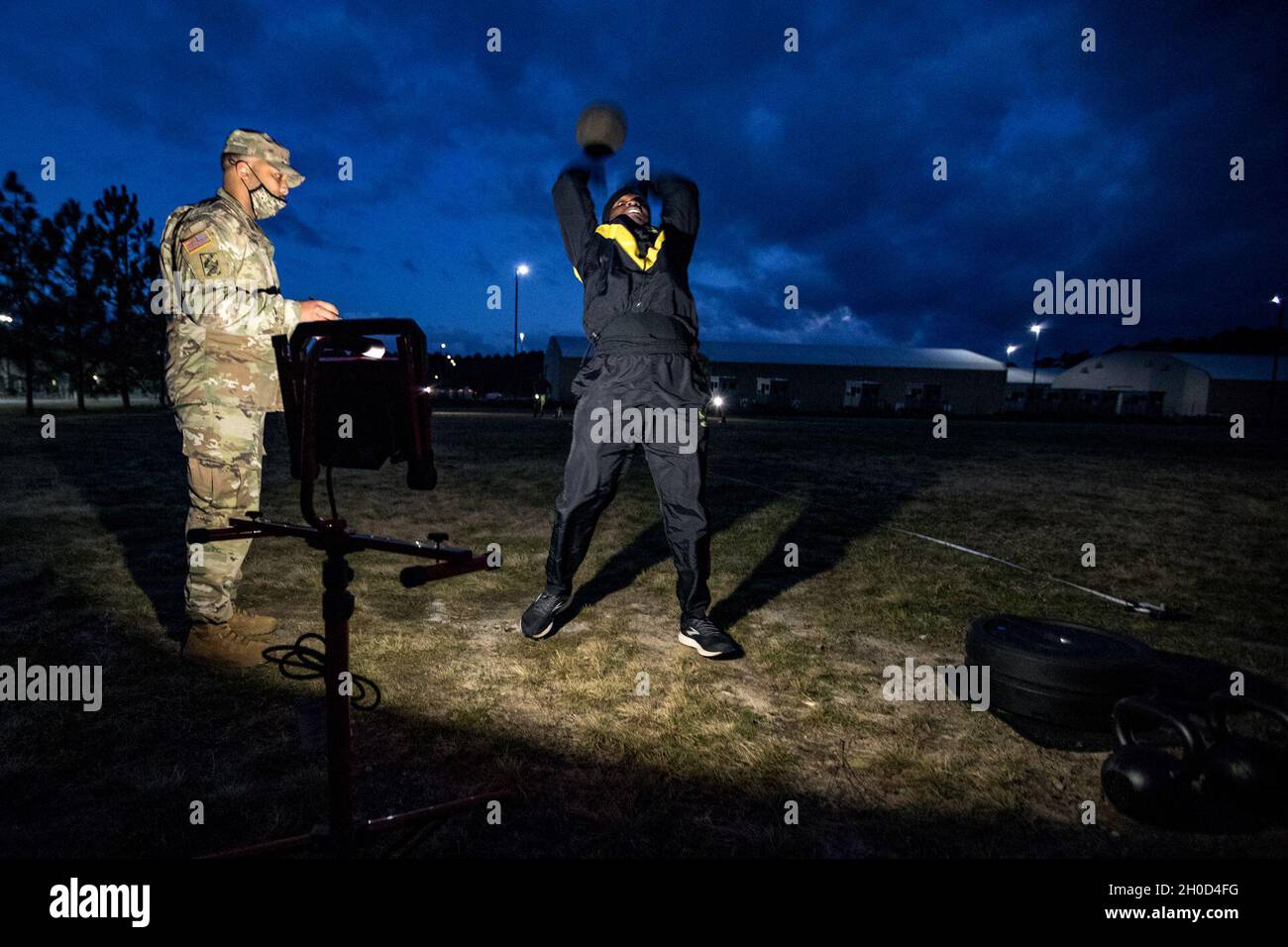 U.S. Army Sgt. Ange Tade, USARCENT, throws a 10-pound medicine ball ...