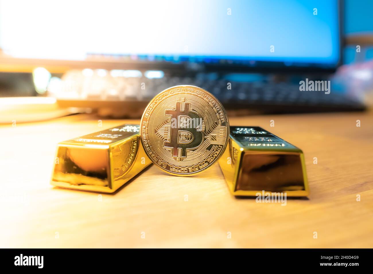 Bitcoin laying on stacked gold bars (gold ingots) rendered with shallow ...