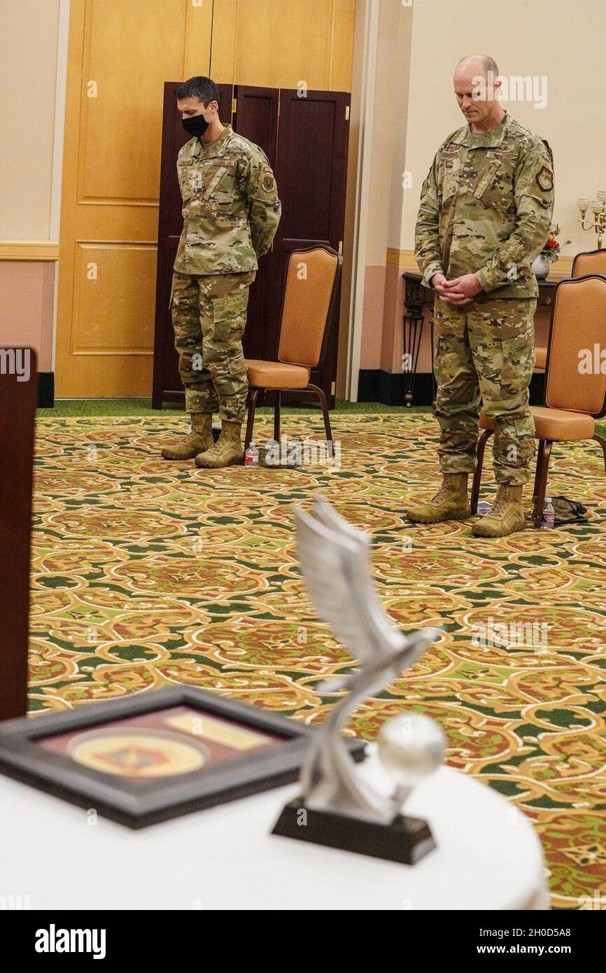 The 688th Cyberspace Wing command team bow their heads in prayer during ...