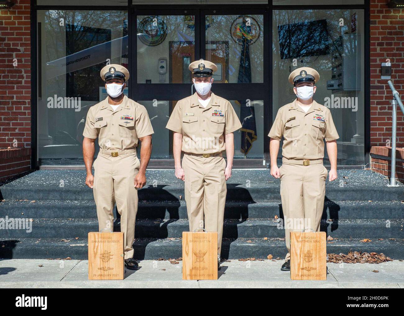 Newly pinned chief petty officers pose for a photo after a chief ...