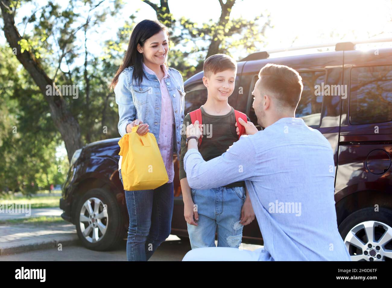 Young parents saying goodbye to their little child near school Stock ...