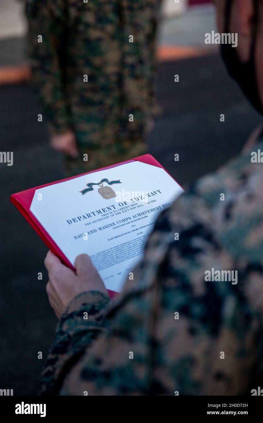 A U.S. Marine reads the Navy and Marine Corps Achievement Medal ...