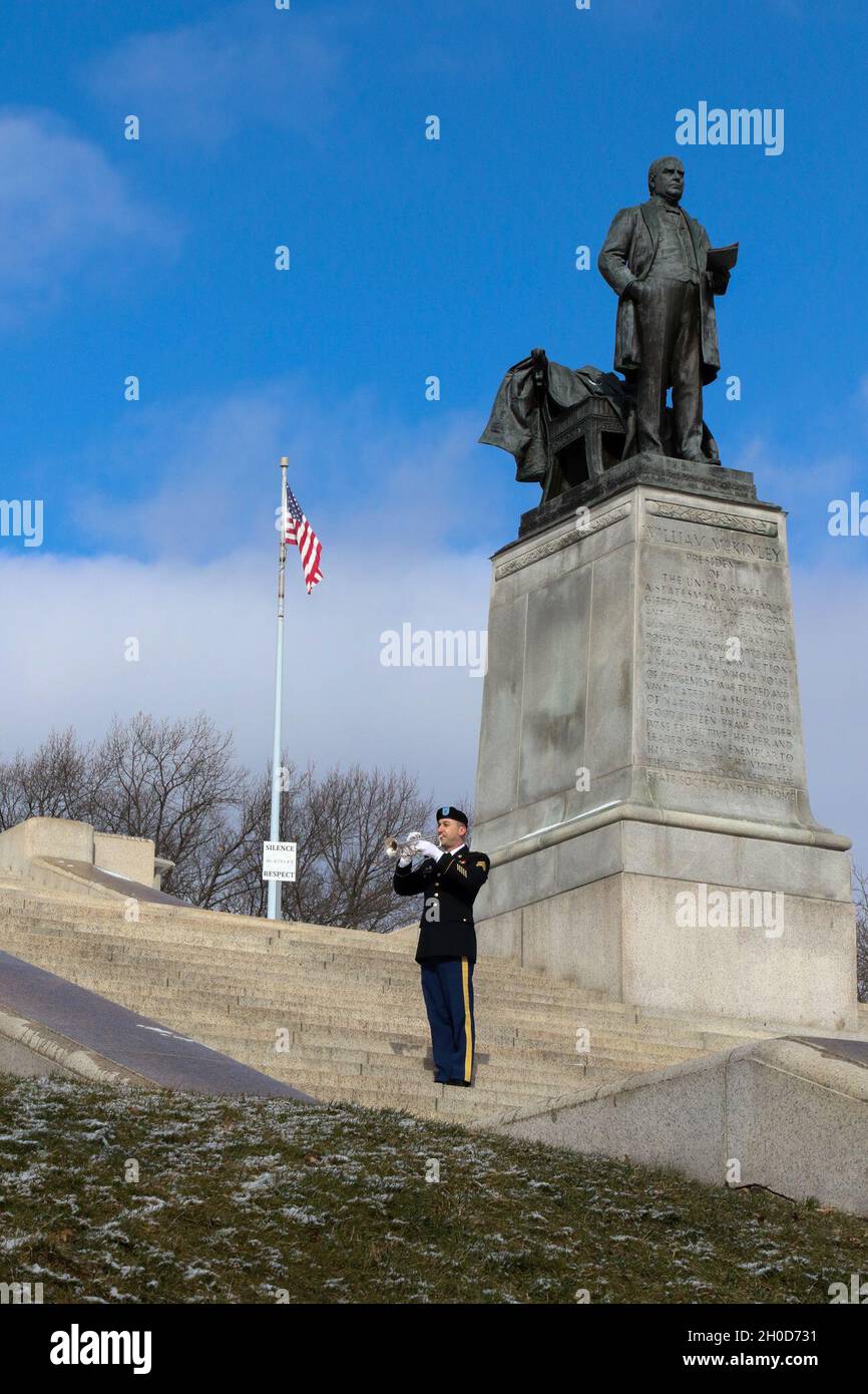 Staff Sgt. Jeff Hotz, bugler, 338th Army Band, plays Taps during the ...