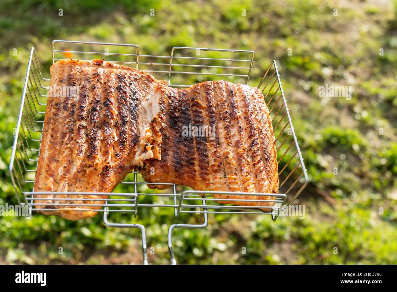Grilled salmon fish steak barbecue meal cooking, prepared on bbq grill ...