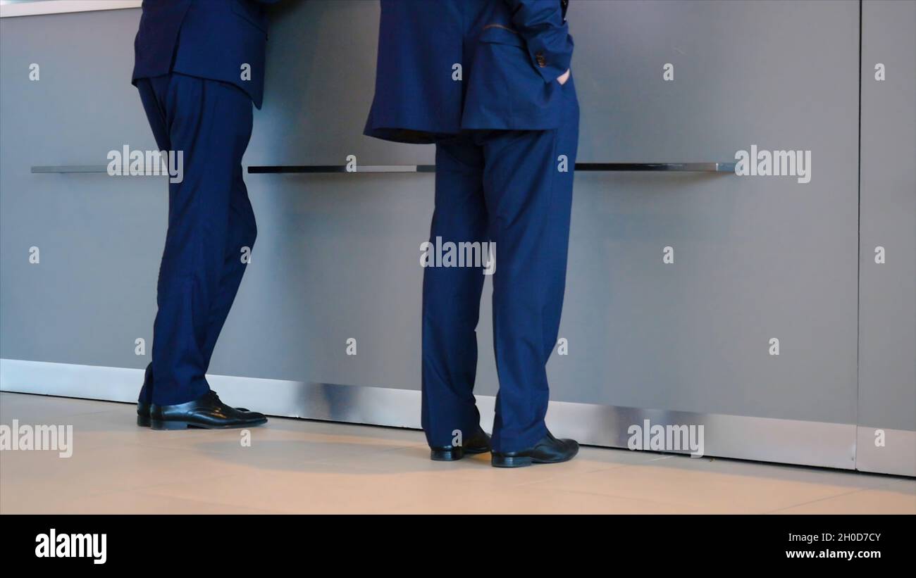 Young businessmen check in at airport reception. Media. Businessmen are ...
