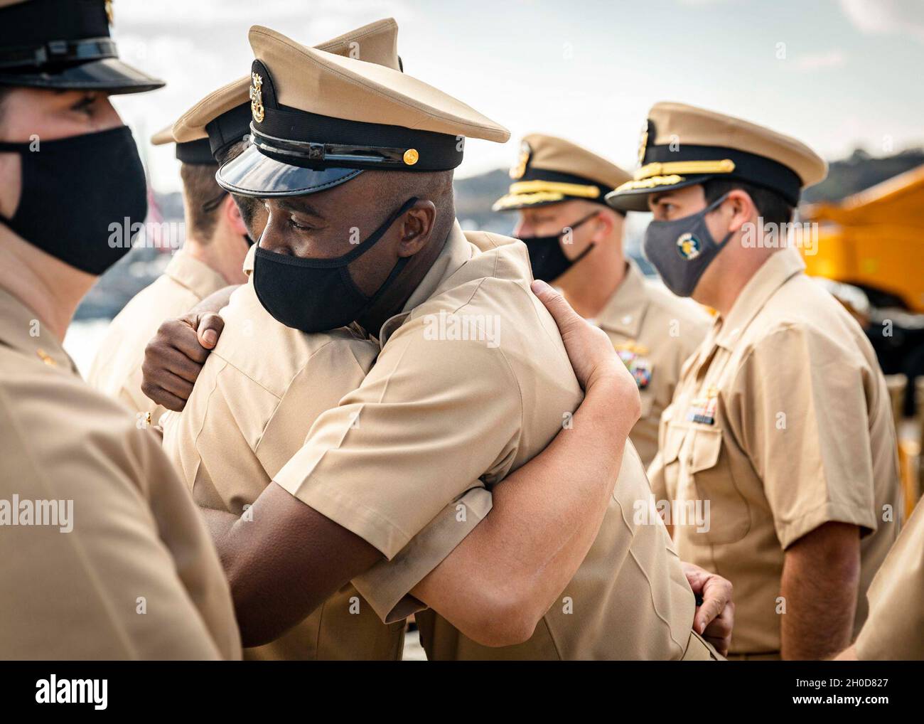 Command Master Chief Mackenson Moise, center, from North Miami Beach ...