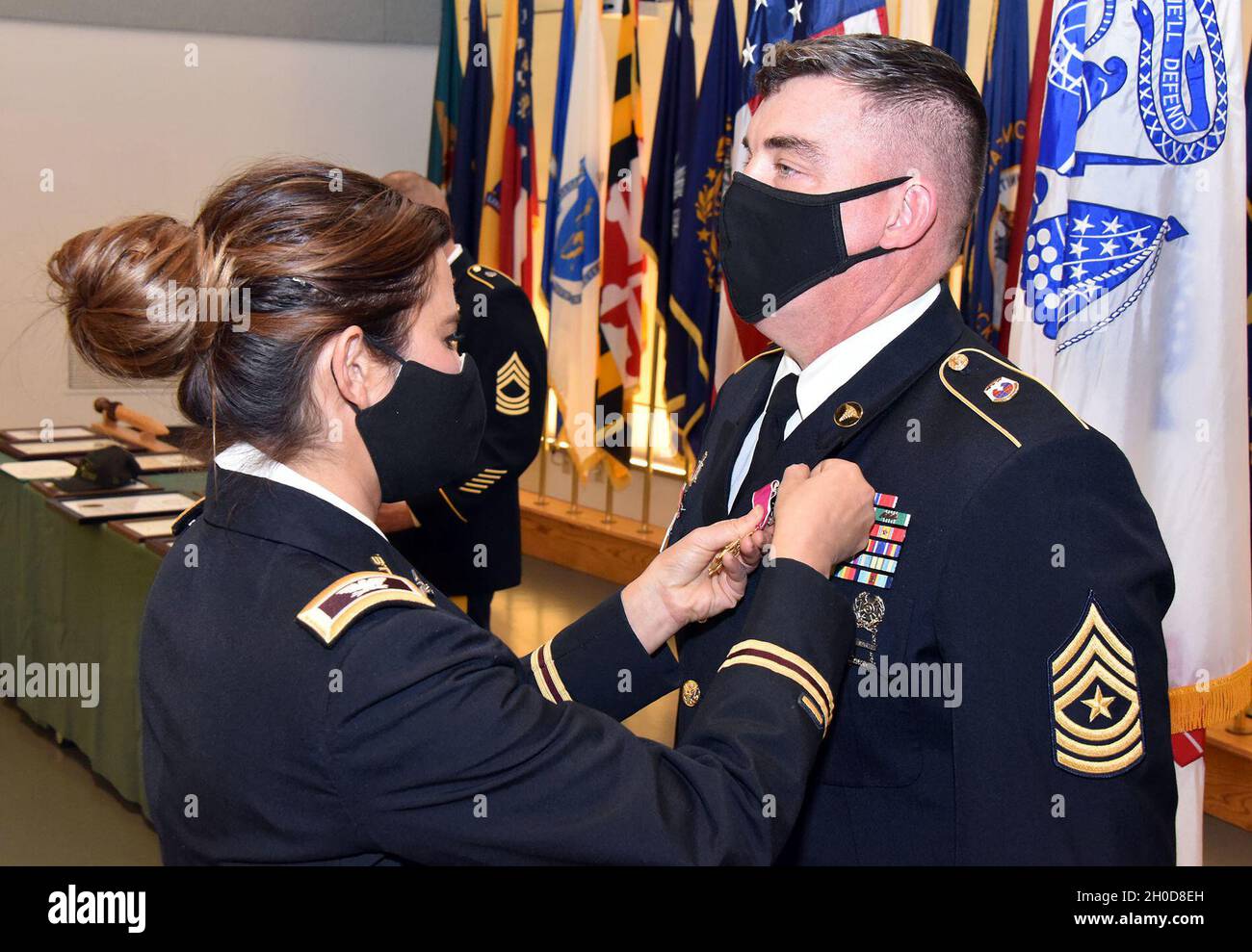 Col. Lynn Marm, left, pins the Legion of Merit medal on to Sgt. Maj ...