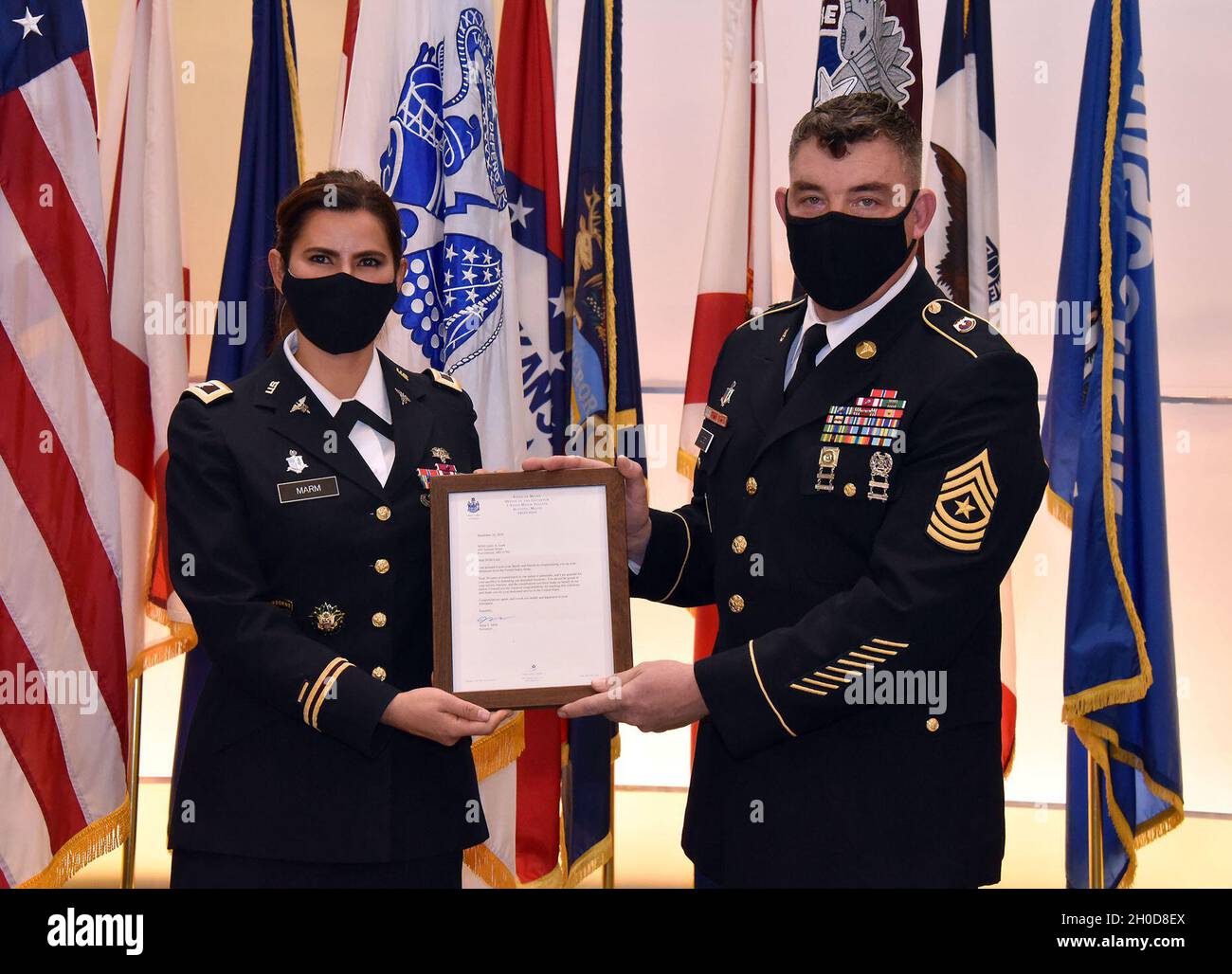 Col. Lynn Marm, left, presents Sgt. Maj. Corey A. Lord with his ...