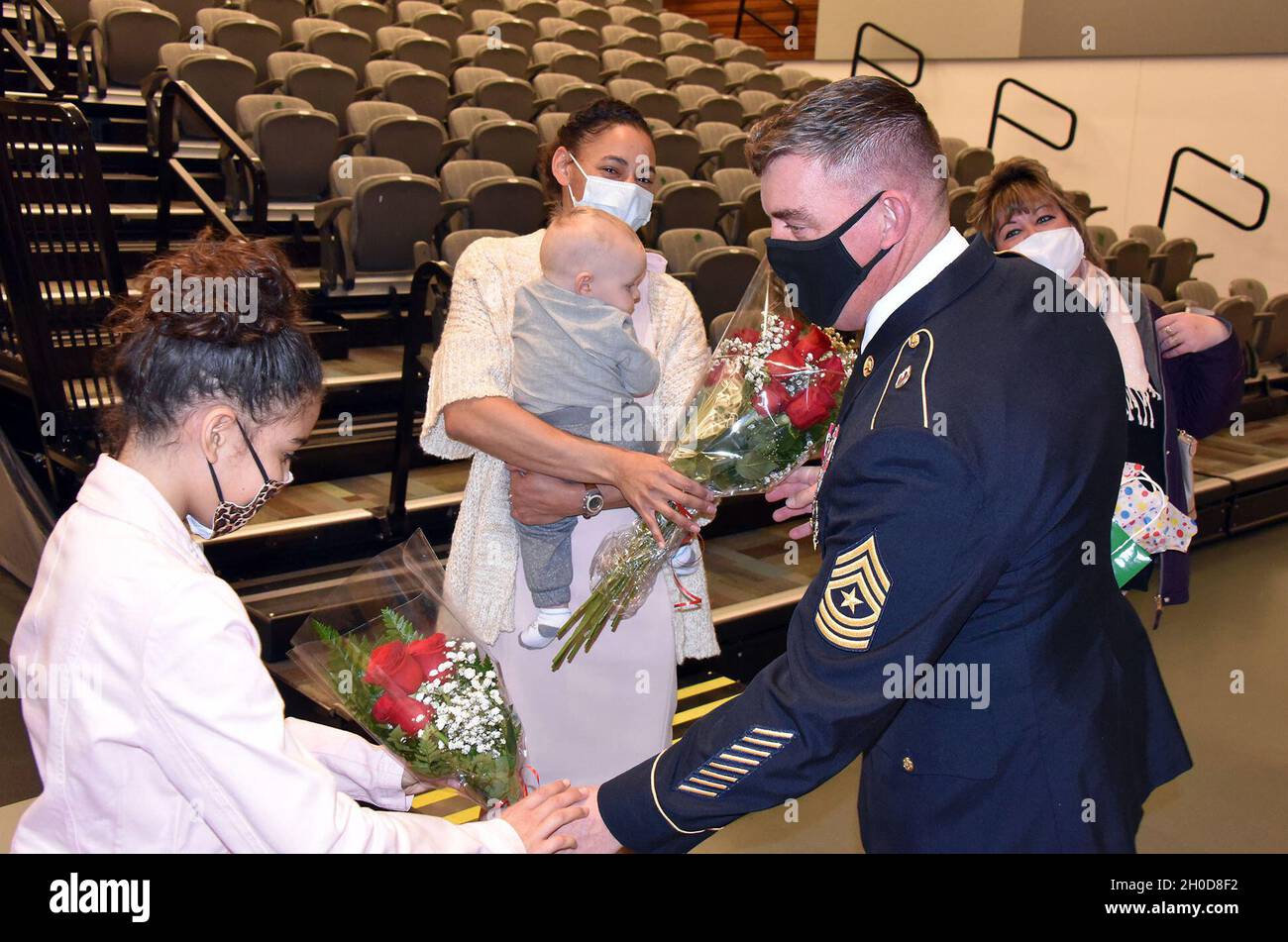 Sgt. Maj. Corey A. Lord presents flowers to his wife, Christiana, and ...