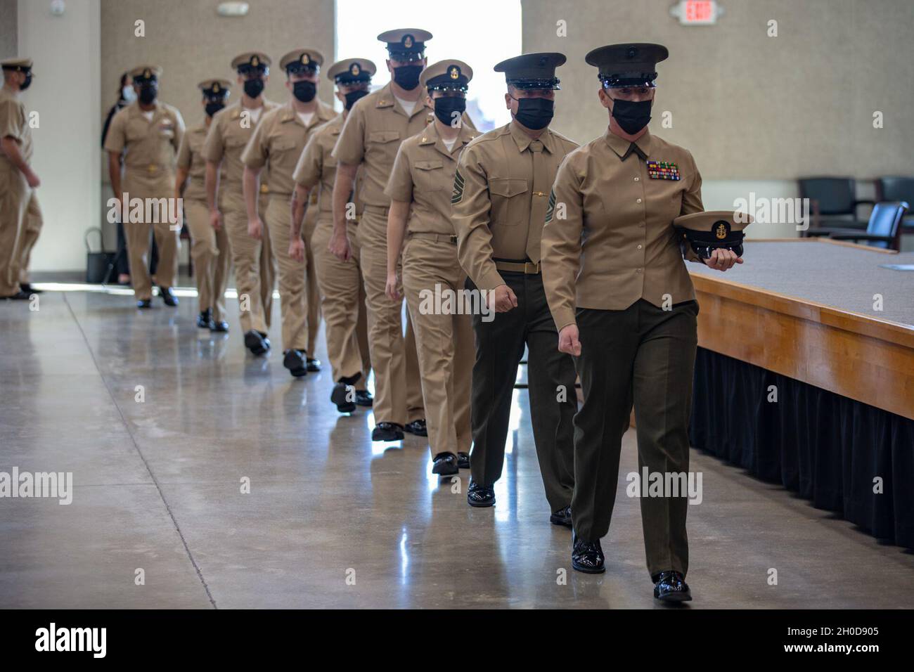 Newly pinned chief petty officers (CPO) march during the CPO pinning ...
