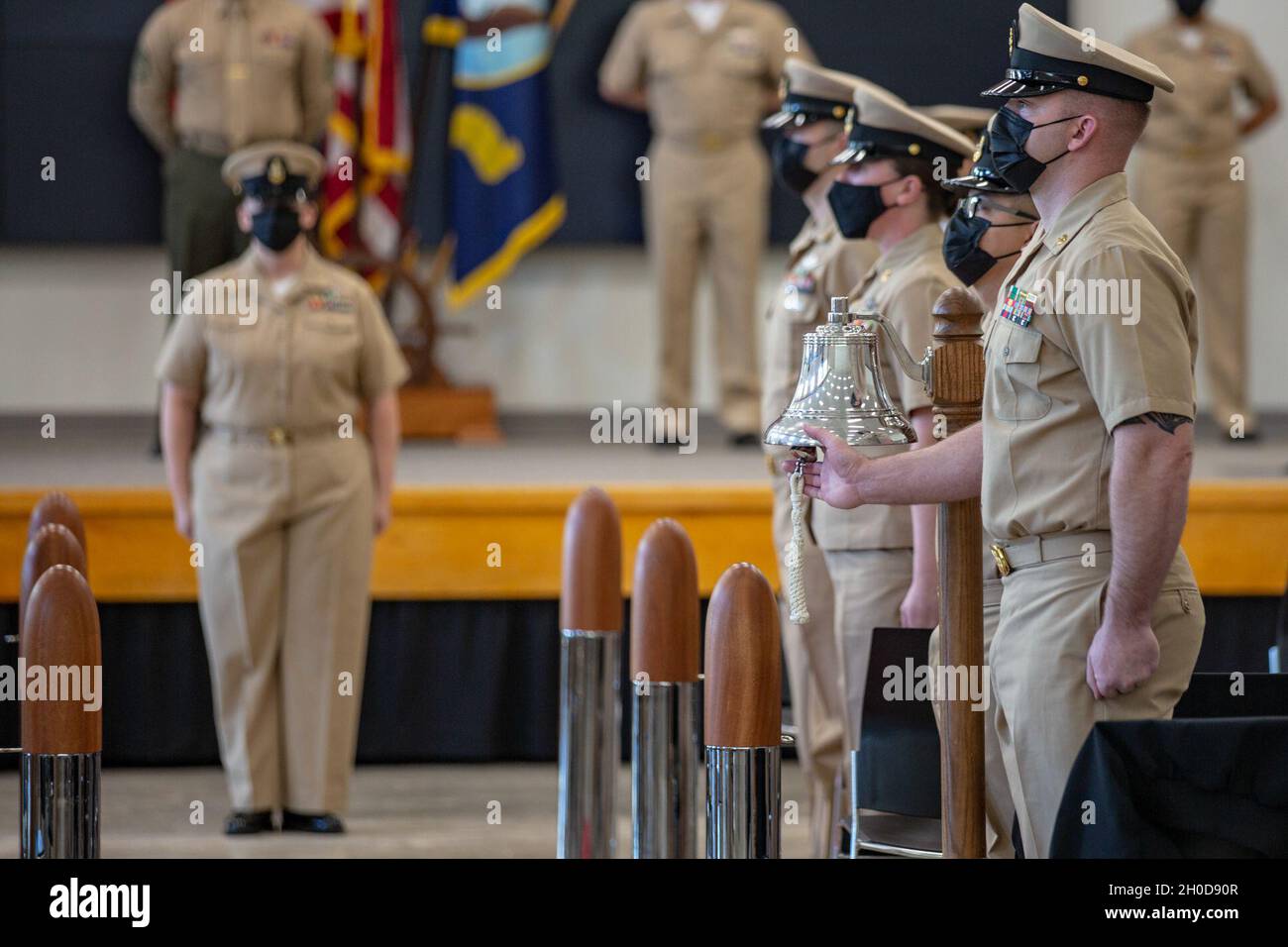 A newly pinned chief petty officer (CPO) prepares to march during the ...