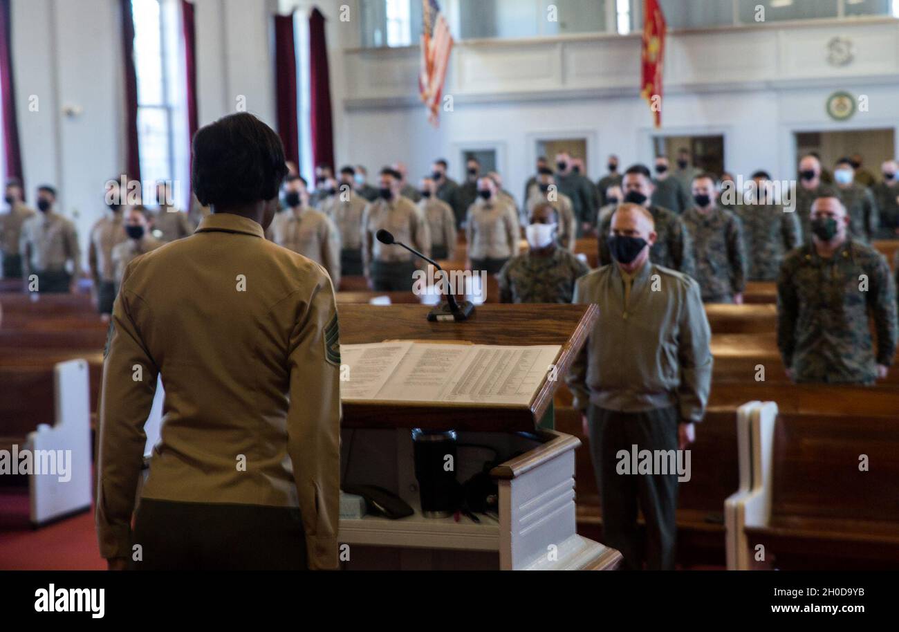 U.S. Marines stand at attention for the playing of “Anchors Aweigh ...