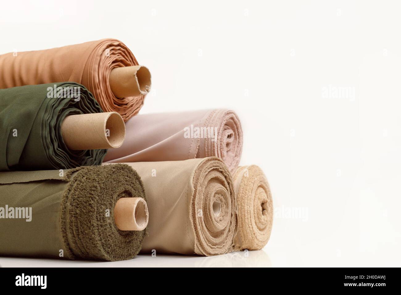 Stack of pastel color fabric rolls isolated on white, Synthetic and ...