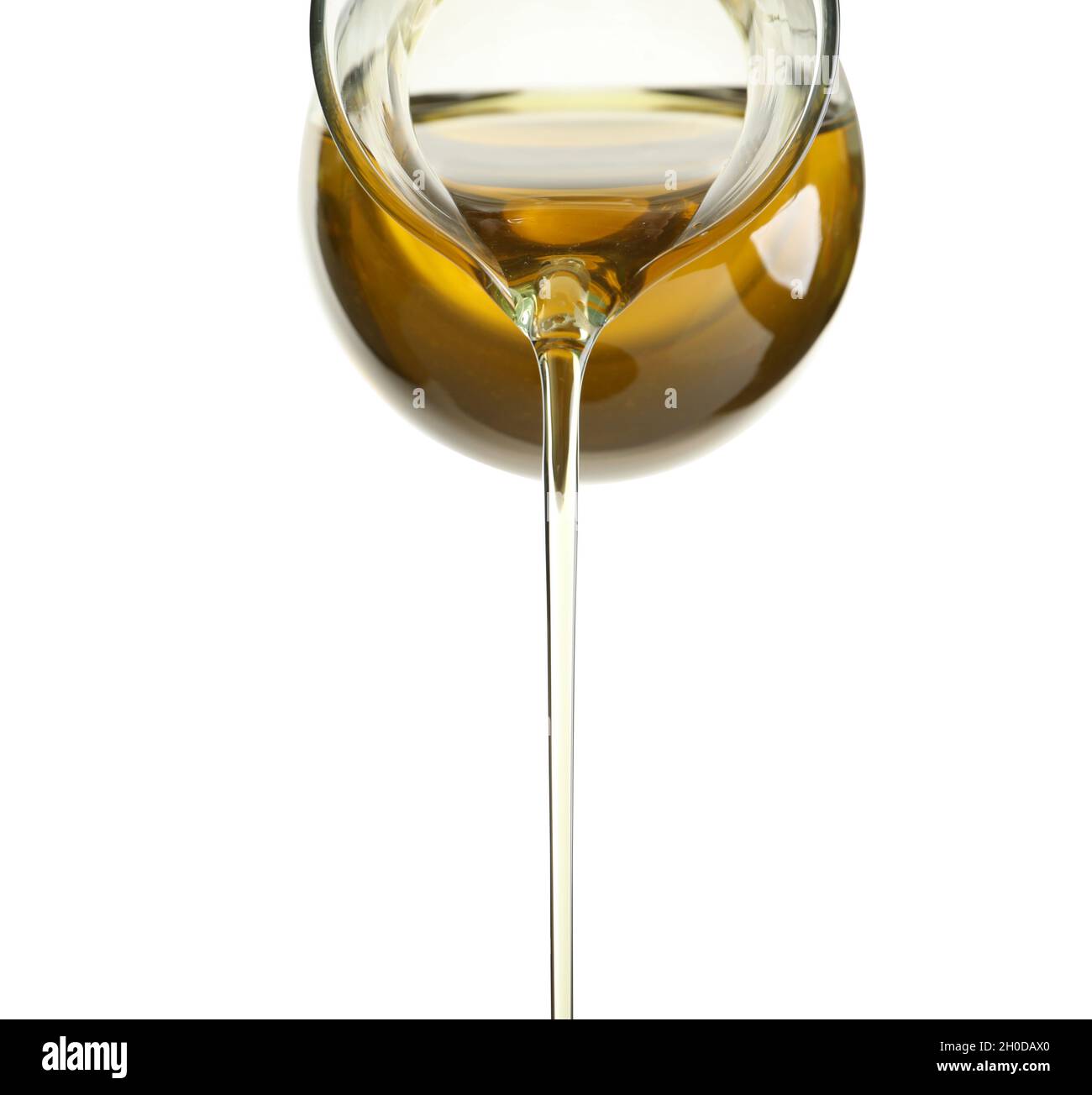 Pouring fresh olive oil on white background Stock Photo - Alamy