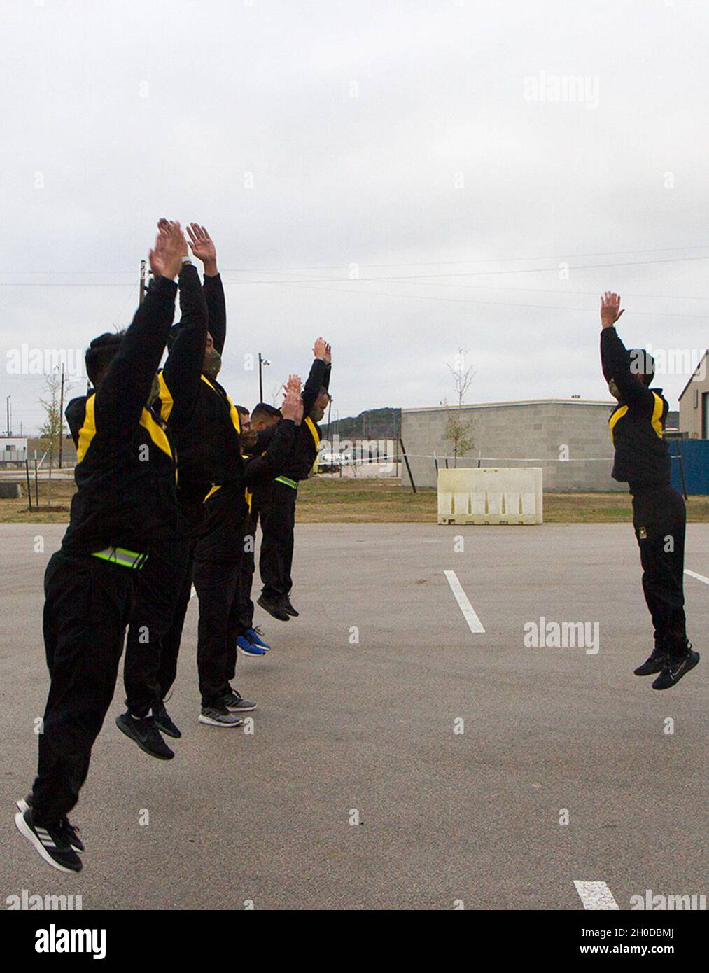 Spc. Anndy Mencias (right), an HR specialist, leads Soldiers in doing ...