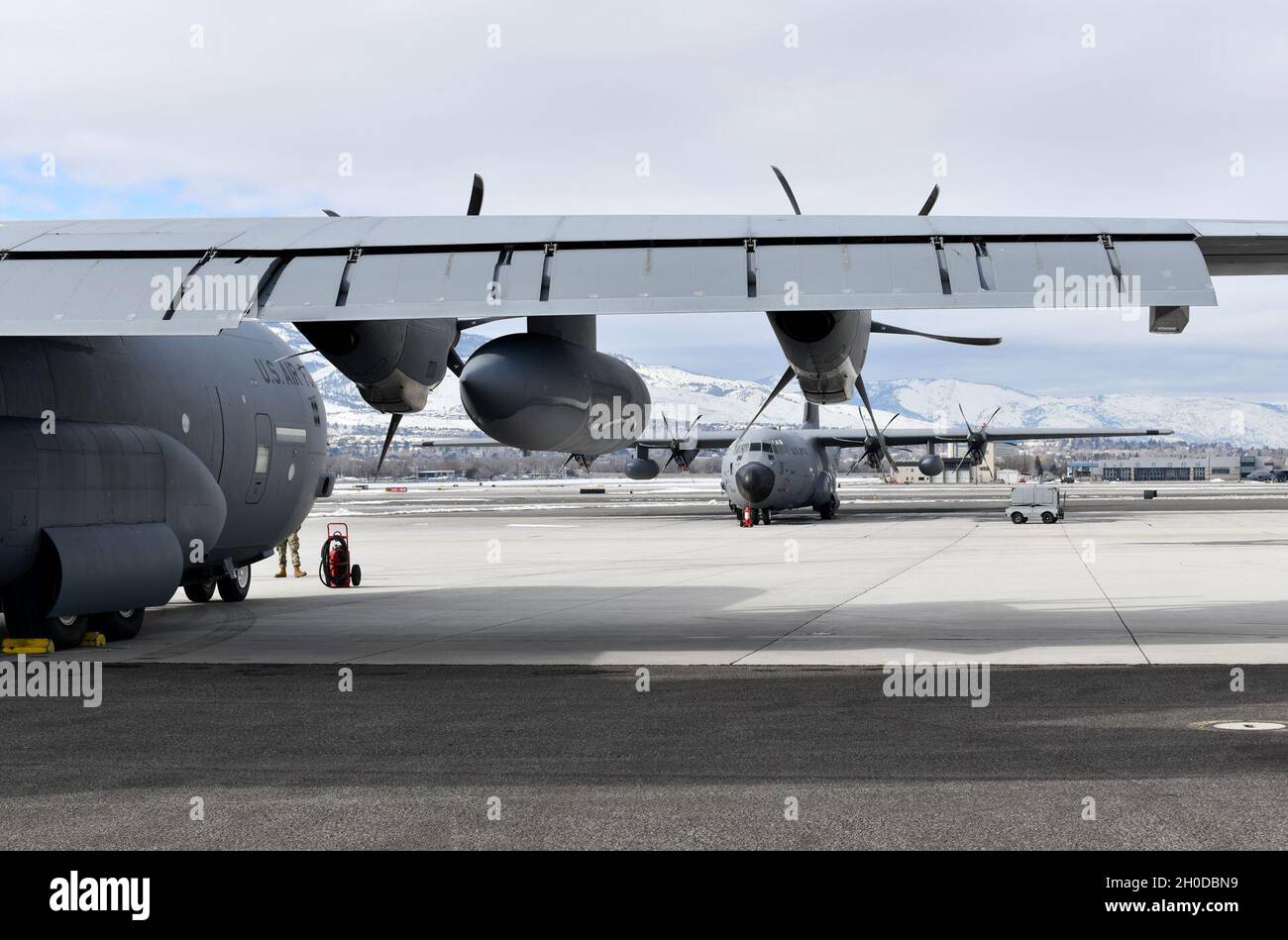 Two 53rd Weather Reconnaissance Squadron WC-130J aircraft sit adjacent ...