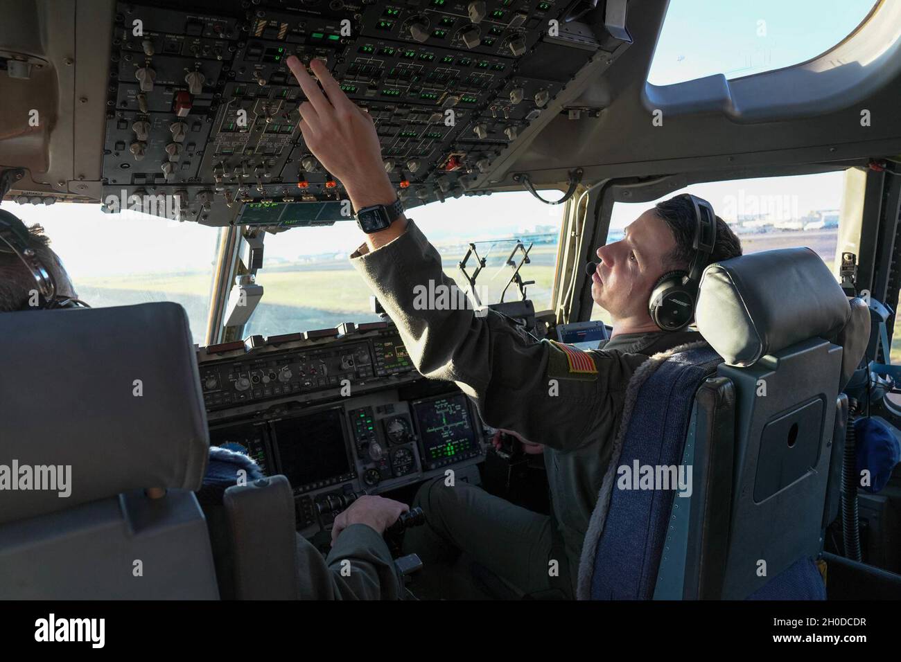 Capt. Garrison Boone, 535th Airlift Squadron pilot, adjusts controls in ...
