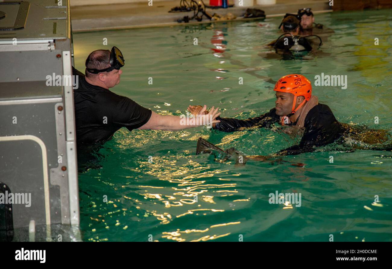 U.S. Marines enter the Modular Amphibious Egress Trainer during ...