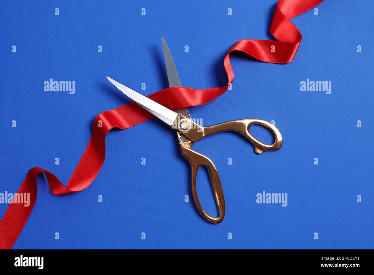 Ribbon and scissors on color background, top view. Ceremonial red tape ...