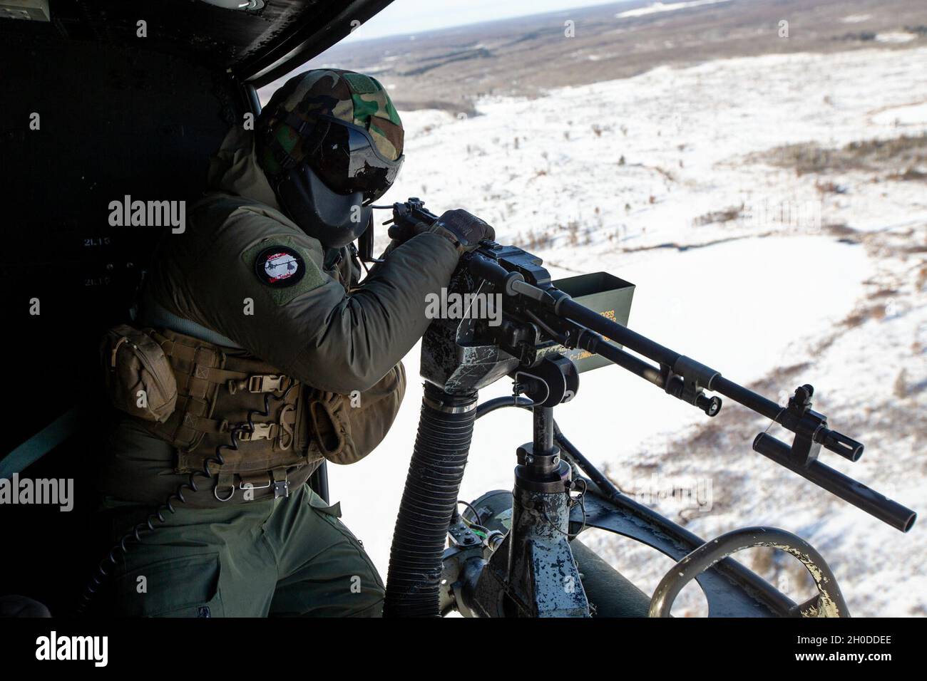 Corporal Sullivan G. Brooks, a UH-1Y Huey crew chief, fires an M240B ...