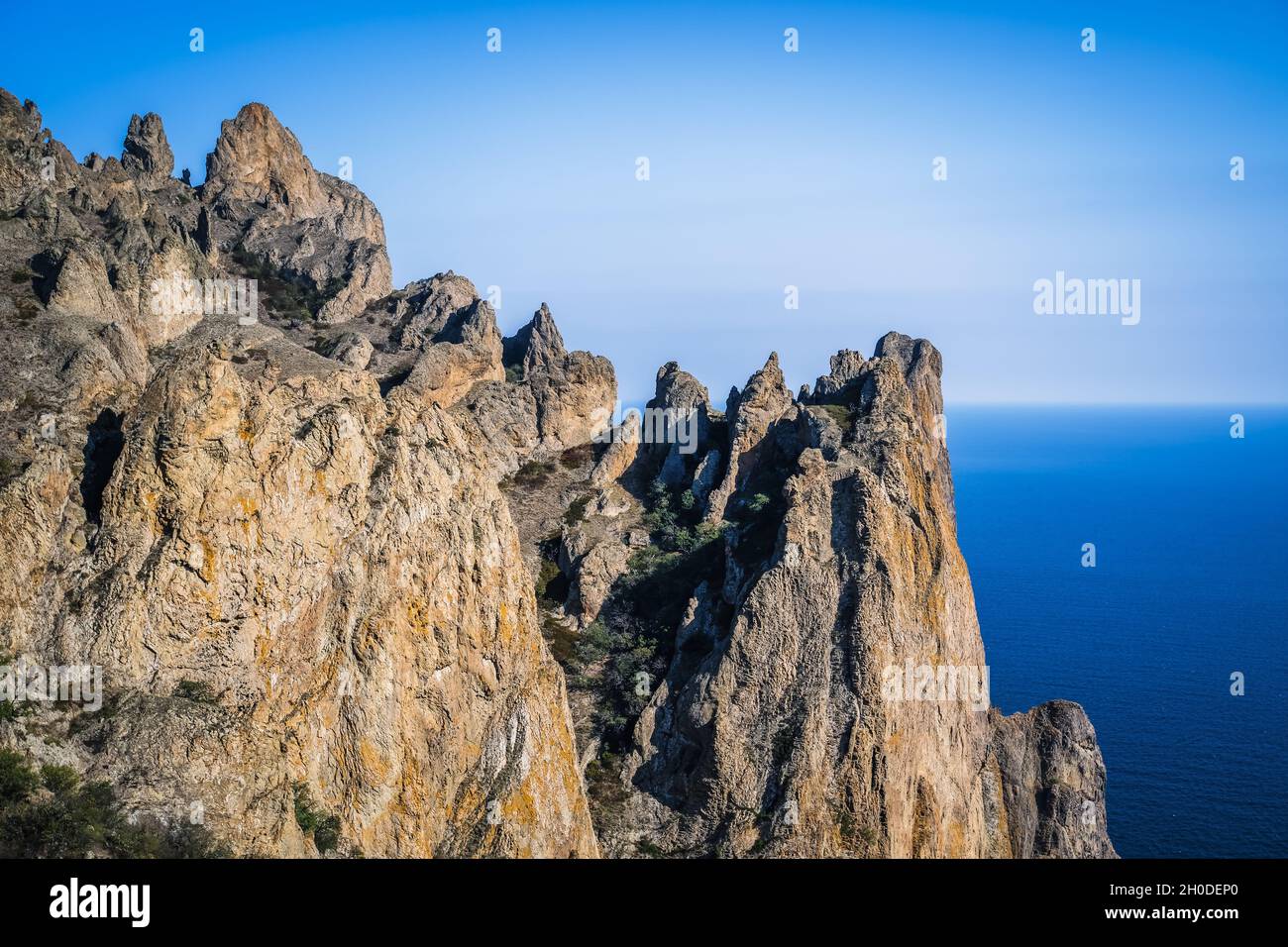 Sheer cliffs near the sea of the volcanic formation Karadag in Koktebel ...