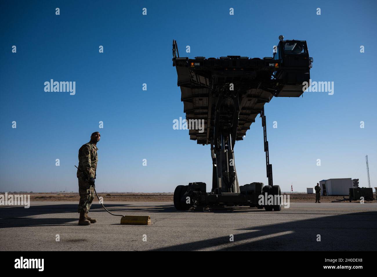 A U.S. Air Force 25K Halvorsen cargo loader moves pallets to a KC-10 ...