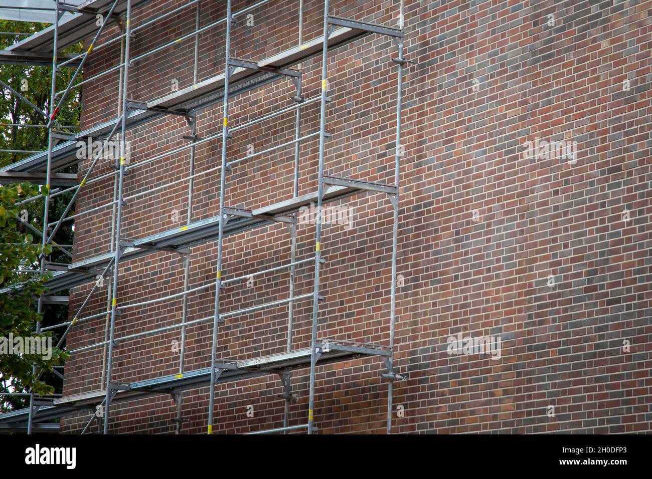 Brick wall building with a protective covering Stock Photo - Alamy
