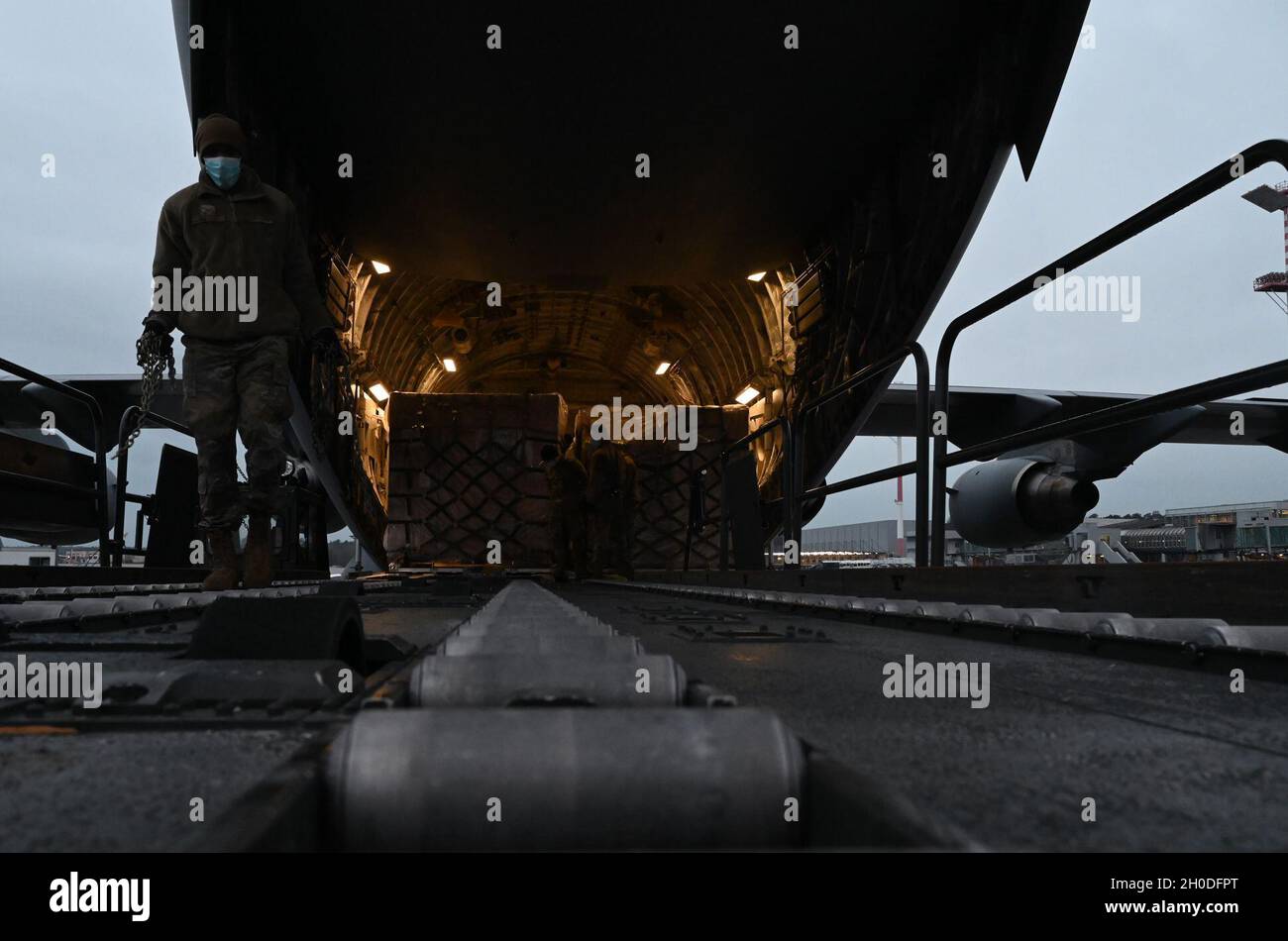 Airmen from the 721st Aerial Port Squadron unload a C-17 Globemaster ...