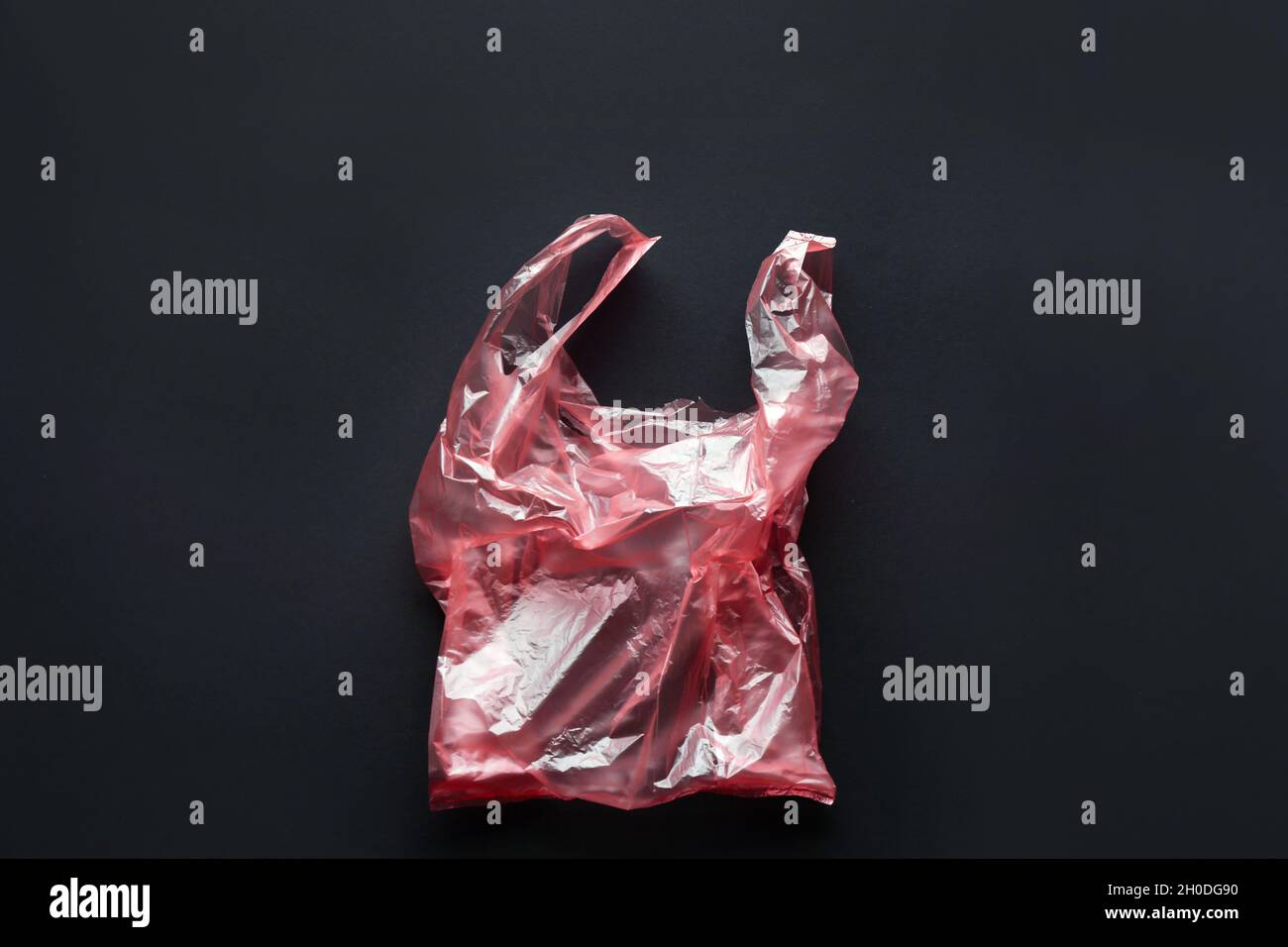 Clear disposable plastic bag on black background Stock Photo - Alamy