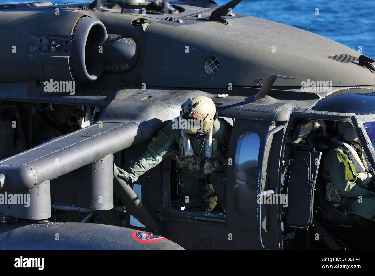 A U.S. Army Aviation Battalion-Japan UH-60 mechanic, helps observe the ...