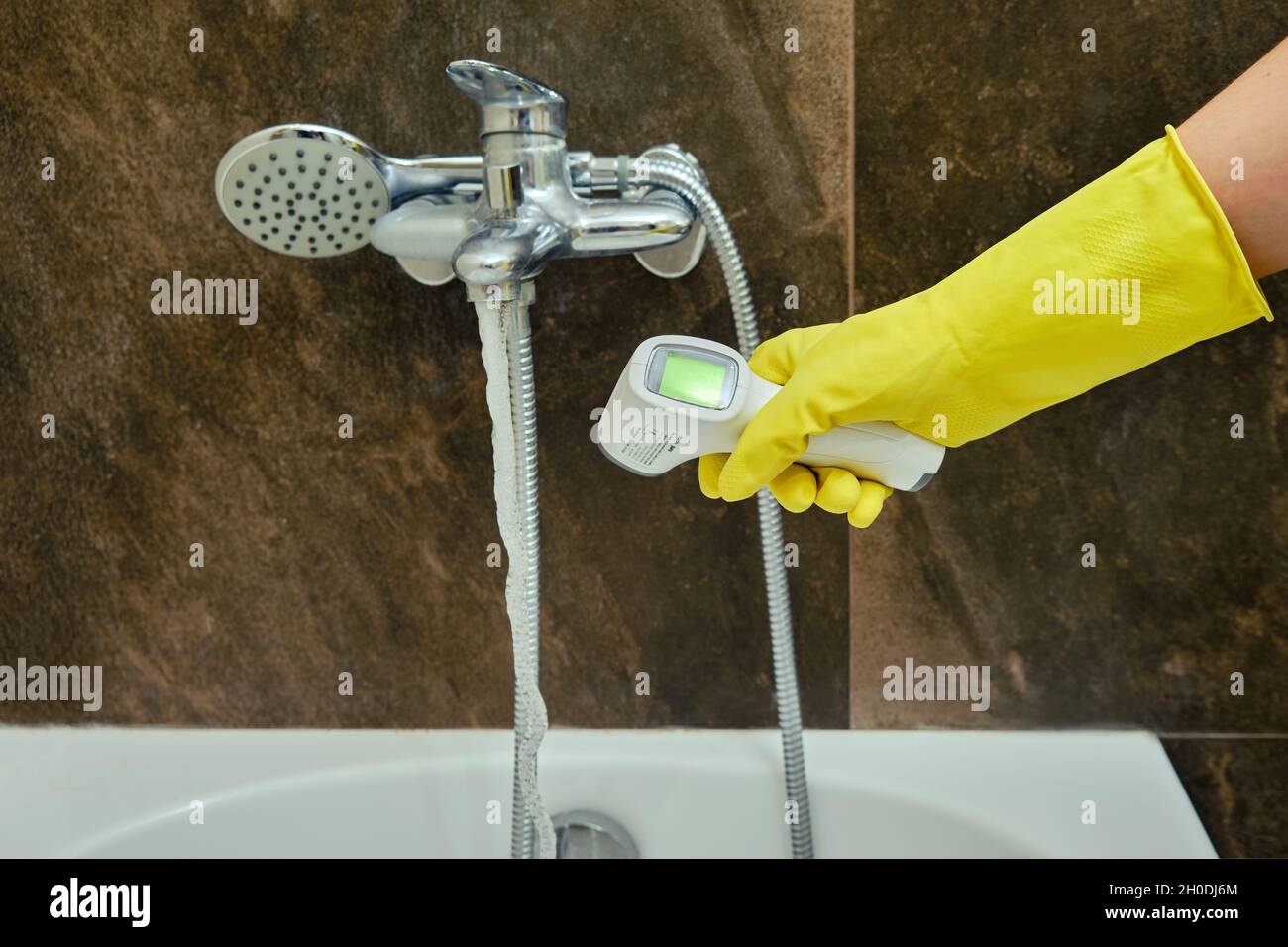 Hand checking water temperature hi-res stock photography and images - Alamy