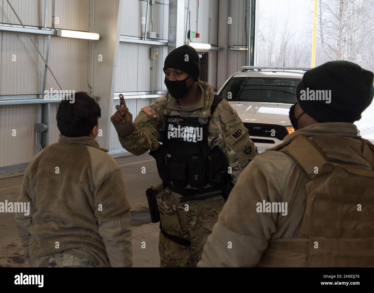 U.S. Army Spc. Derian Callwood, center, a 673d Security Forces Squadron ...