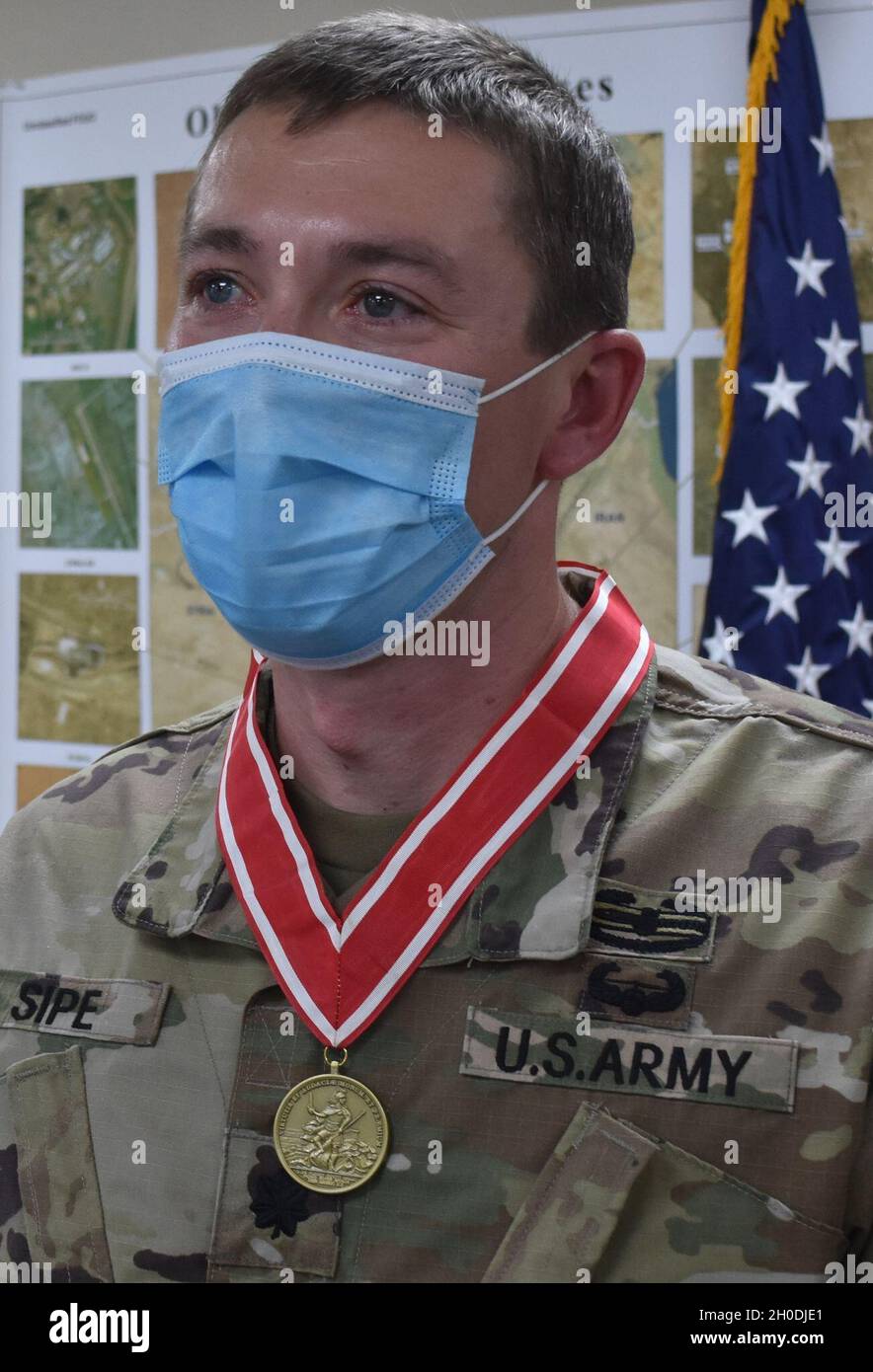 Lieutenant Commander Paul Sipe dons his recent award as he was ...