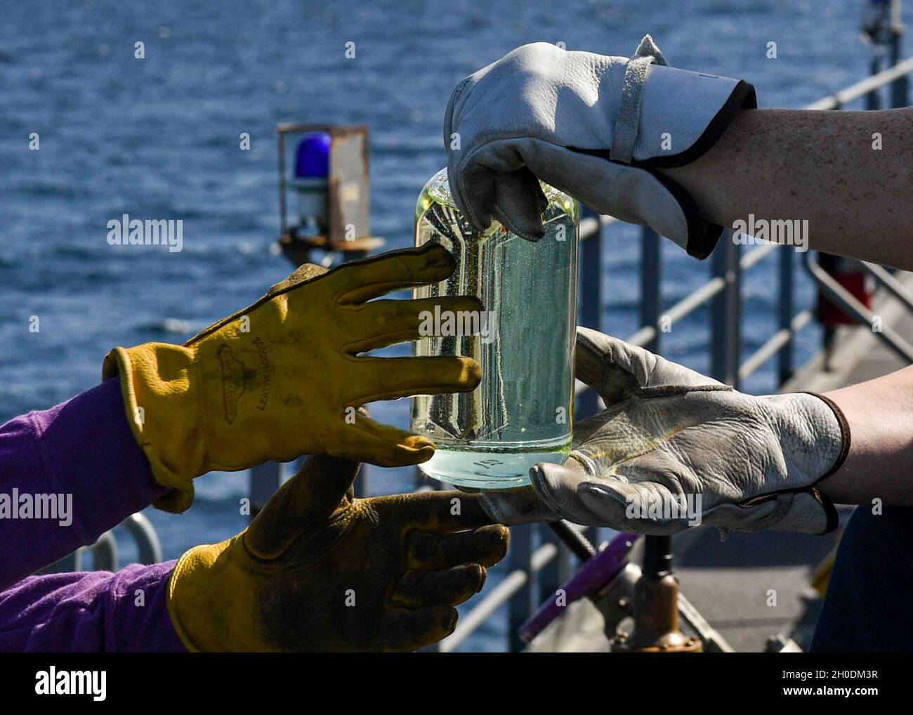 HORN OF AFRICA (February 03, 2021) A JP-5 fuel sample is passed between ...