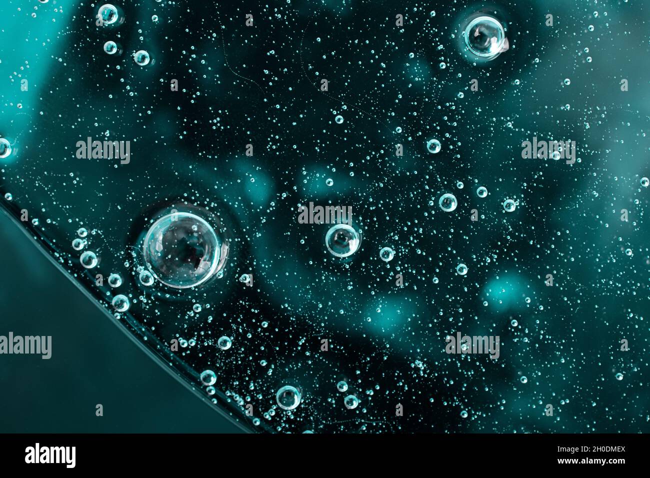 Liquid smear,cosmetics swatch on the turquoise background.Top view ...