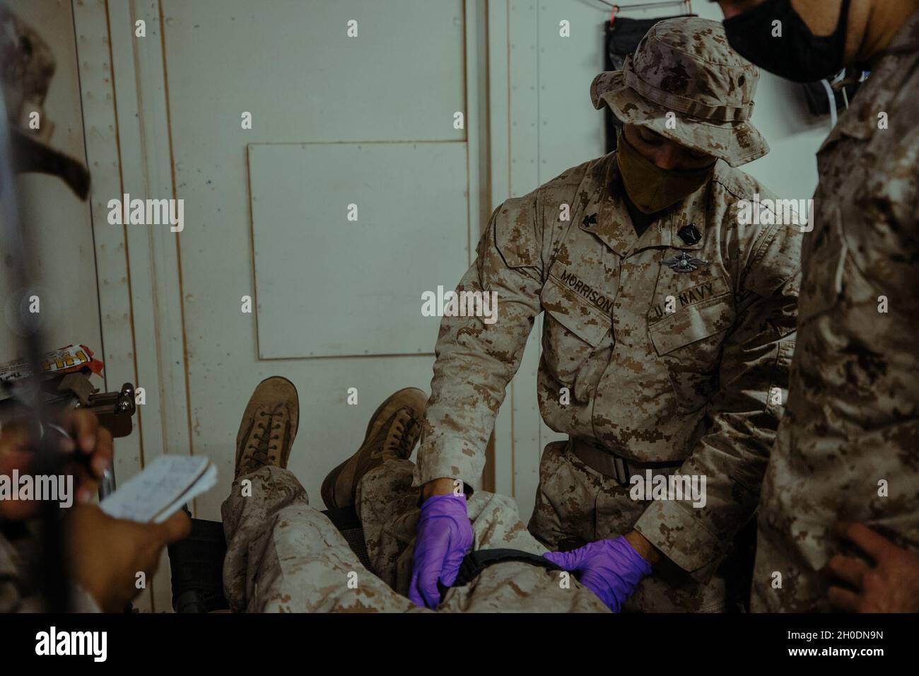 U.S. Navy Sailor Hospital Corpsman Second Class Bryant Morrison treats ...