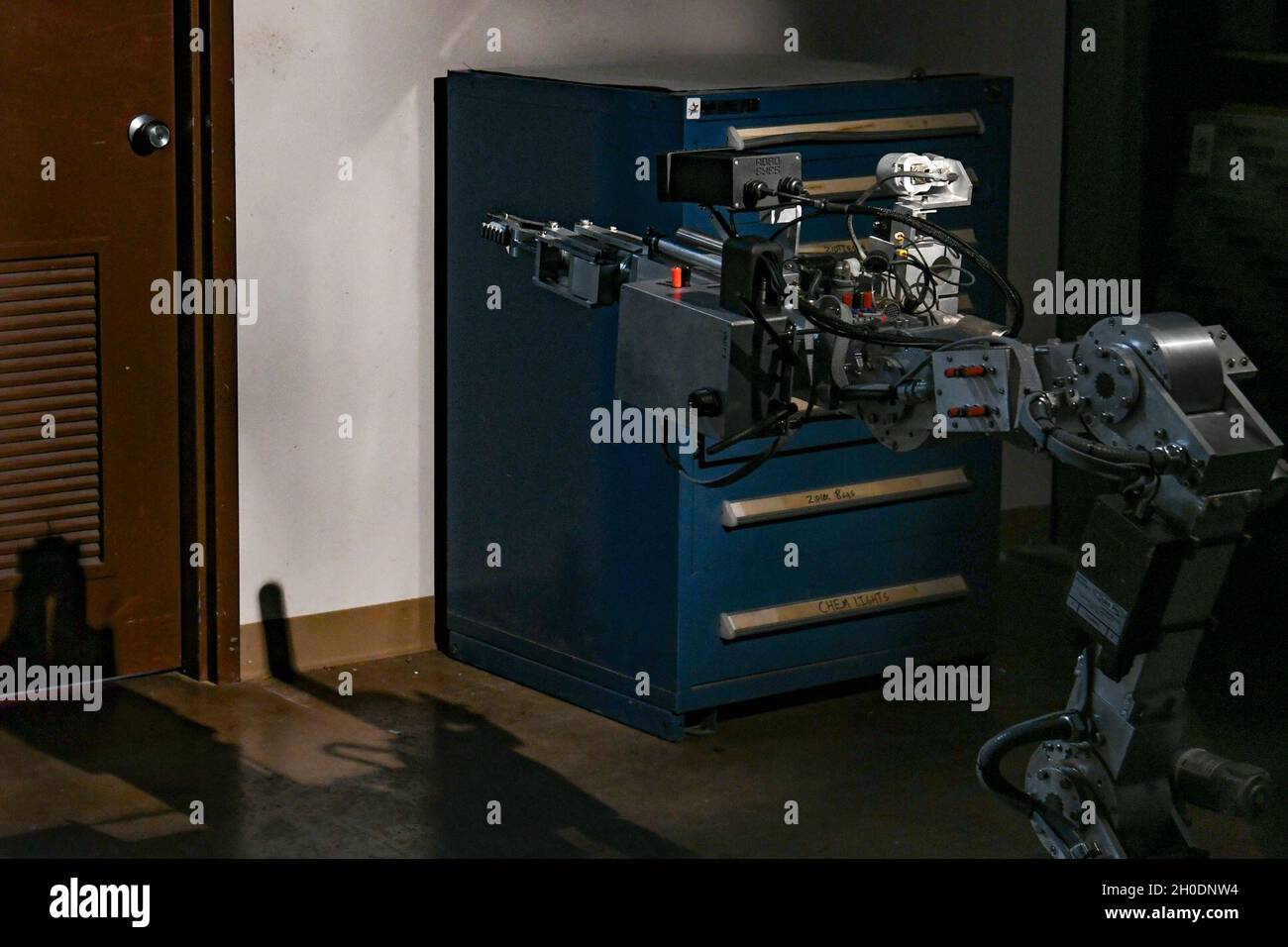 An Explosive Ordnance Disposal F6 robot prepares to put a key into the ...