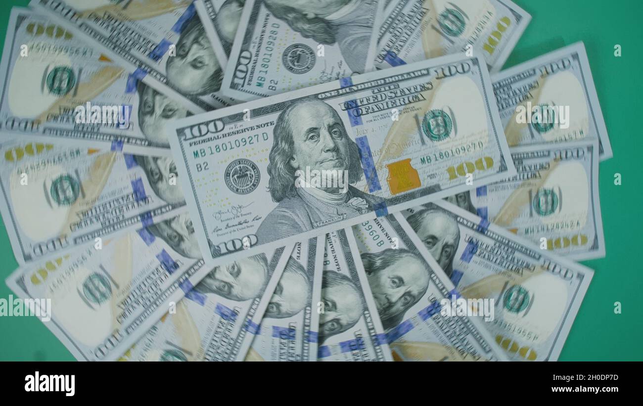 Many dollar are arranged around the edges of the image as a frame ...