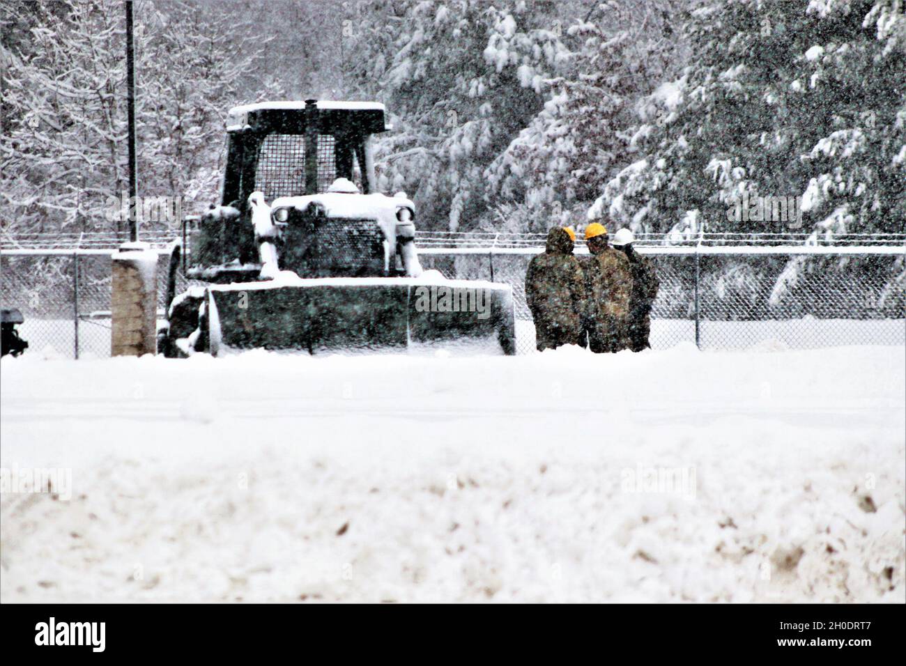 A Regional Training Site-Maintenance staff member drives a grader to ...