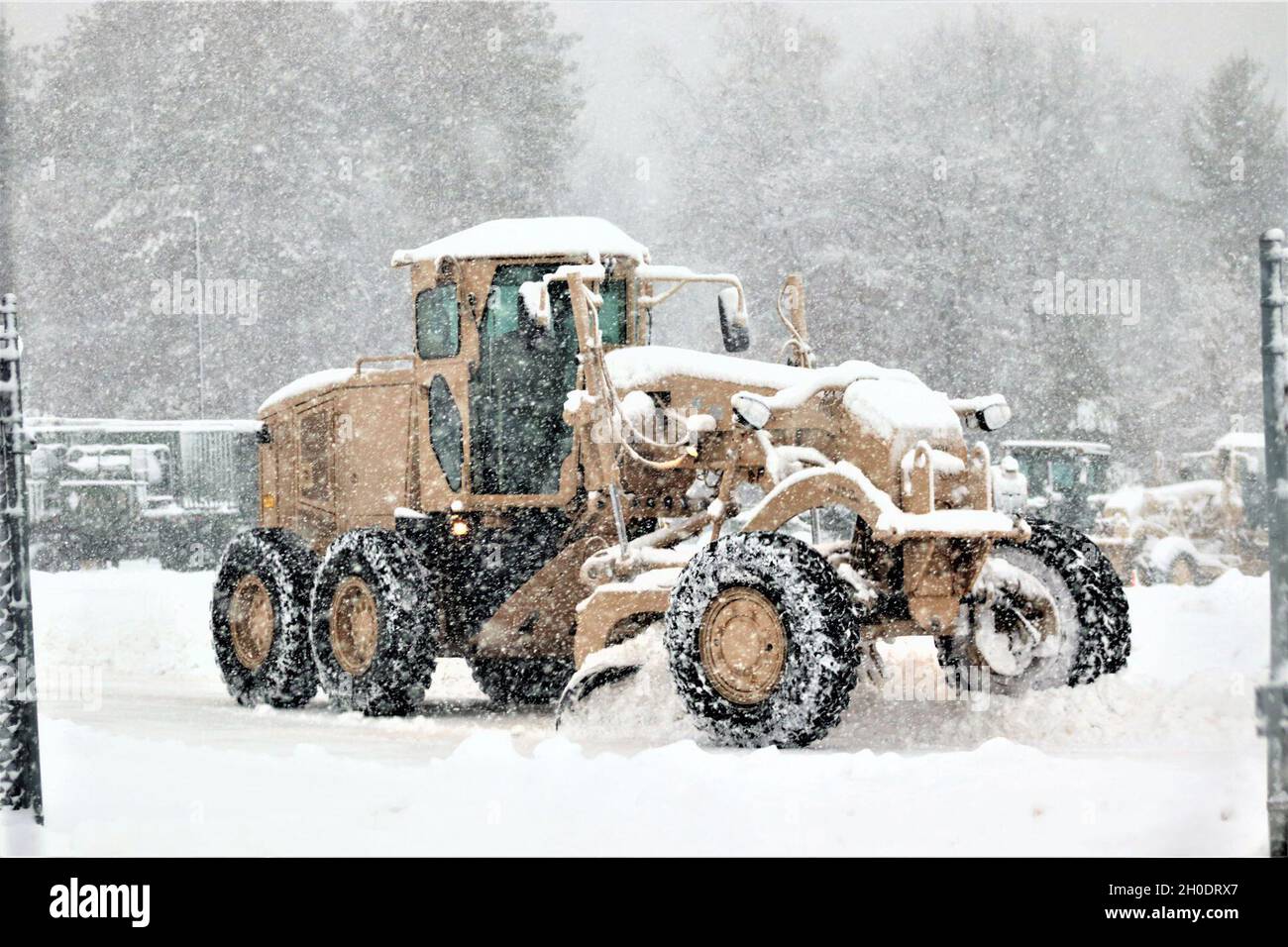 A Regional Training Site-Maintenance staff member drives a grader to ...