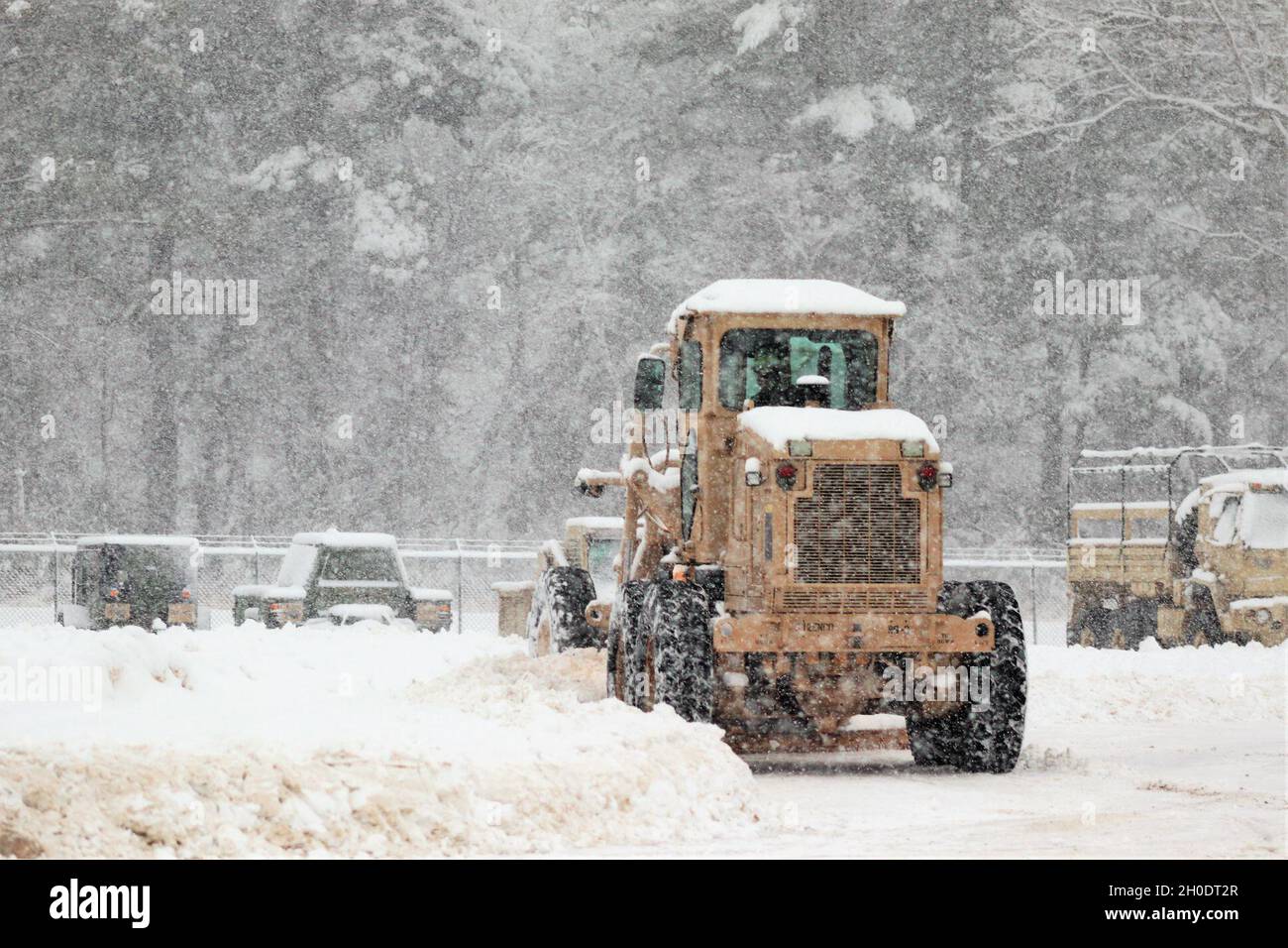 A Regional Training Site-Maintenance staff member drives a grader to ...