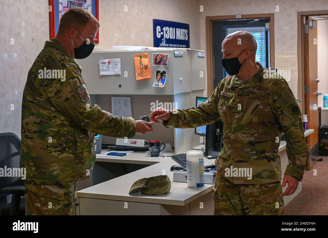 Col. Joseph Miller, 314th Airlift Wing commander, gives a coin to ...