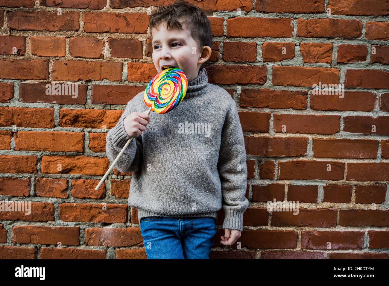 Little boy eating and all day sucker Stock Photo - Alamy