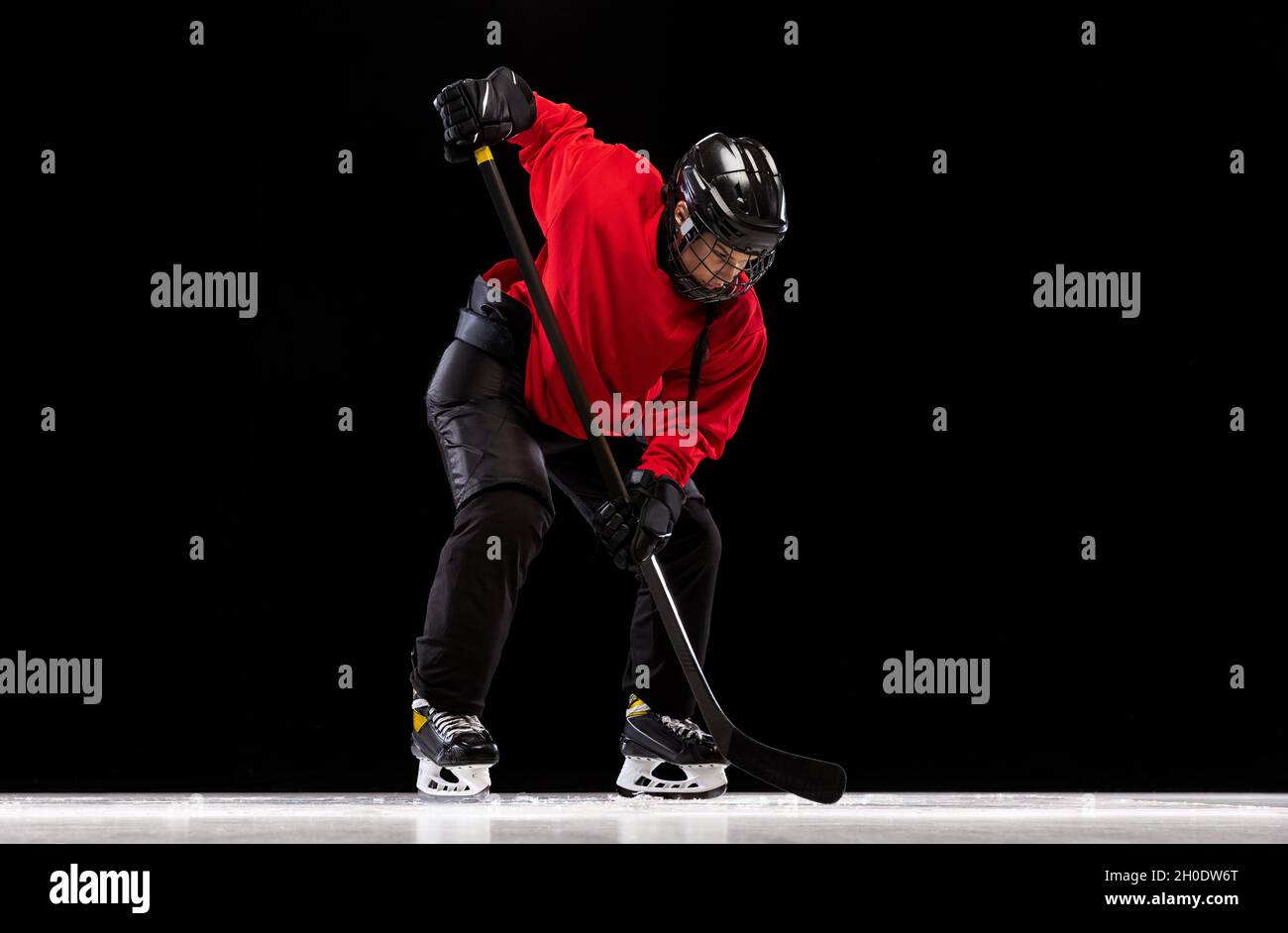 Full-length portrait of professional female hockey player training ...