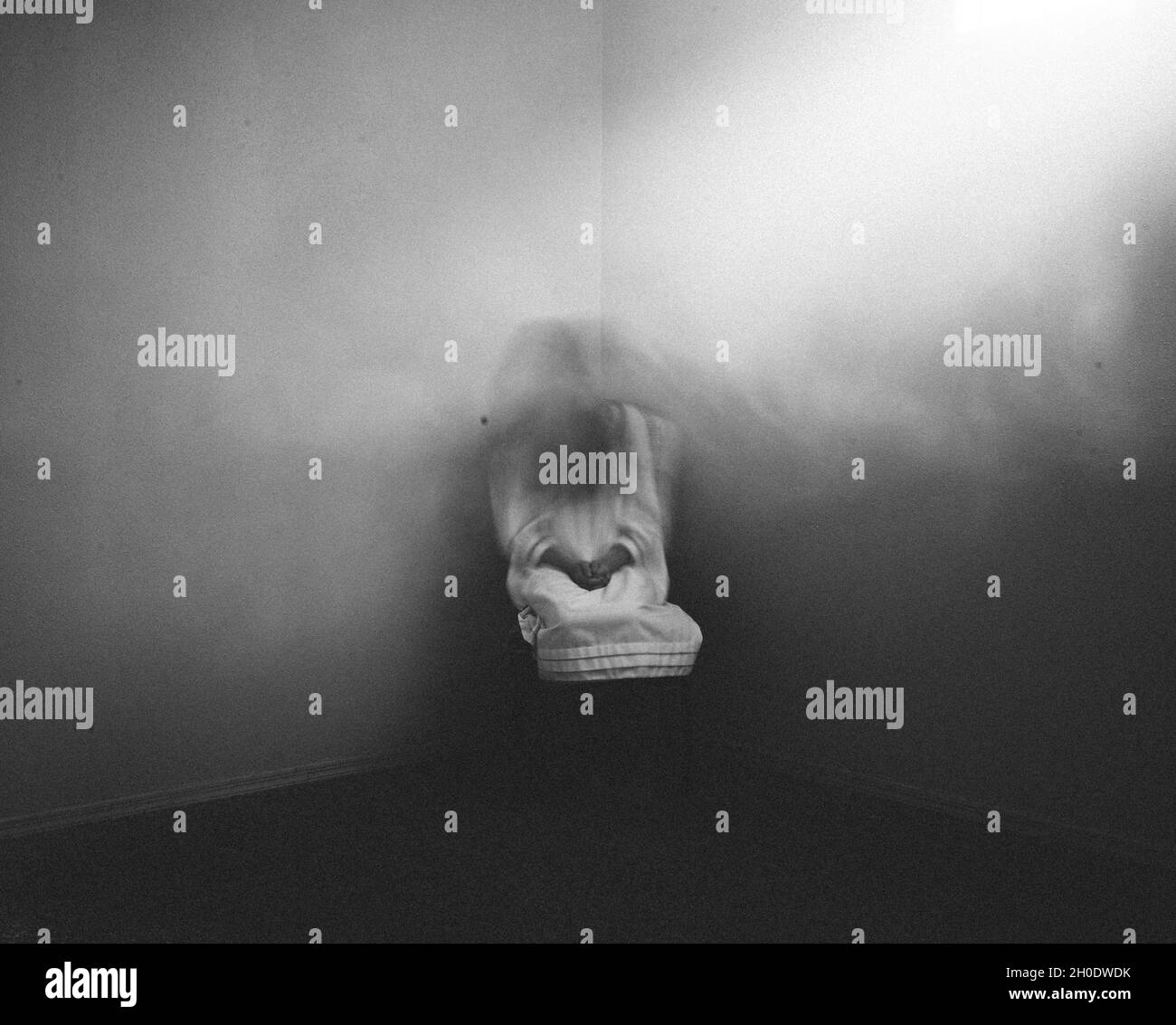 Scary ghost girl sitting in foggy haunted corner of house Stock Photo ...