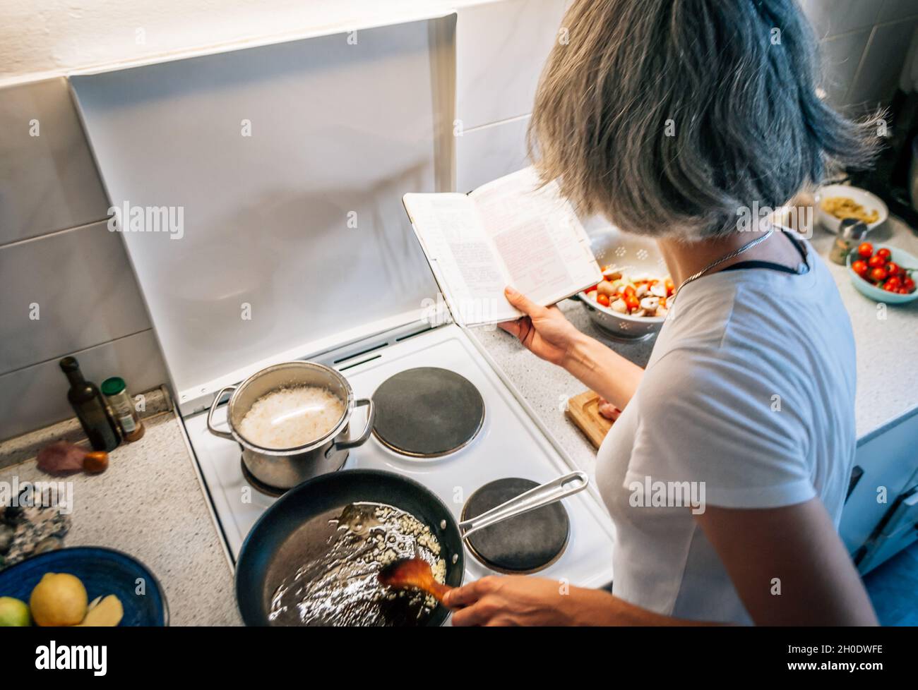 Woman cooks in kitchen hi-res stock photography and images - Alamy