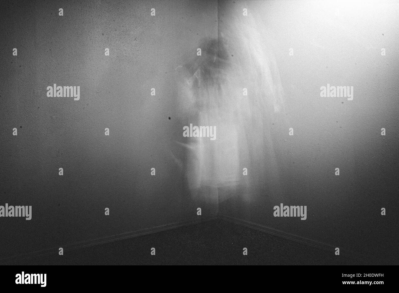 Ghostly figure watching from the corner of the room Stock Photo - Alamy