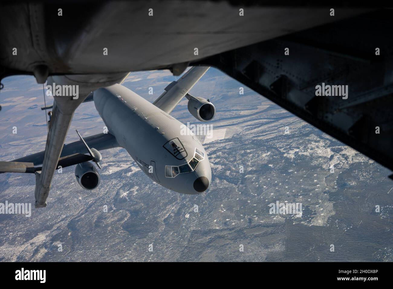A KC-10 Extender flies into position to make contact with the boom of ...